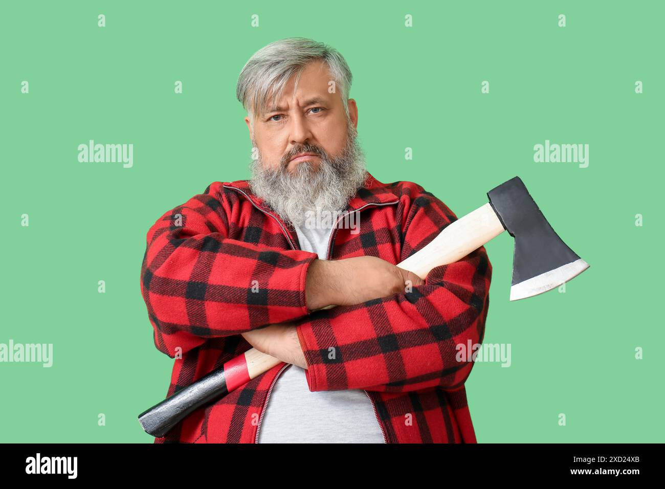 Portrait of mature lumberjack with axe on green background Stock Photo ...