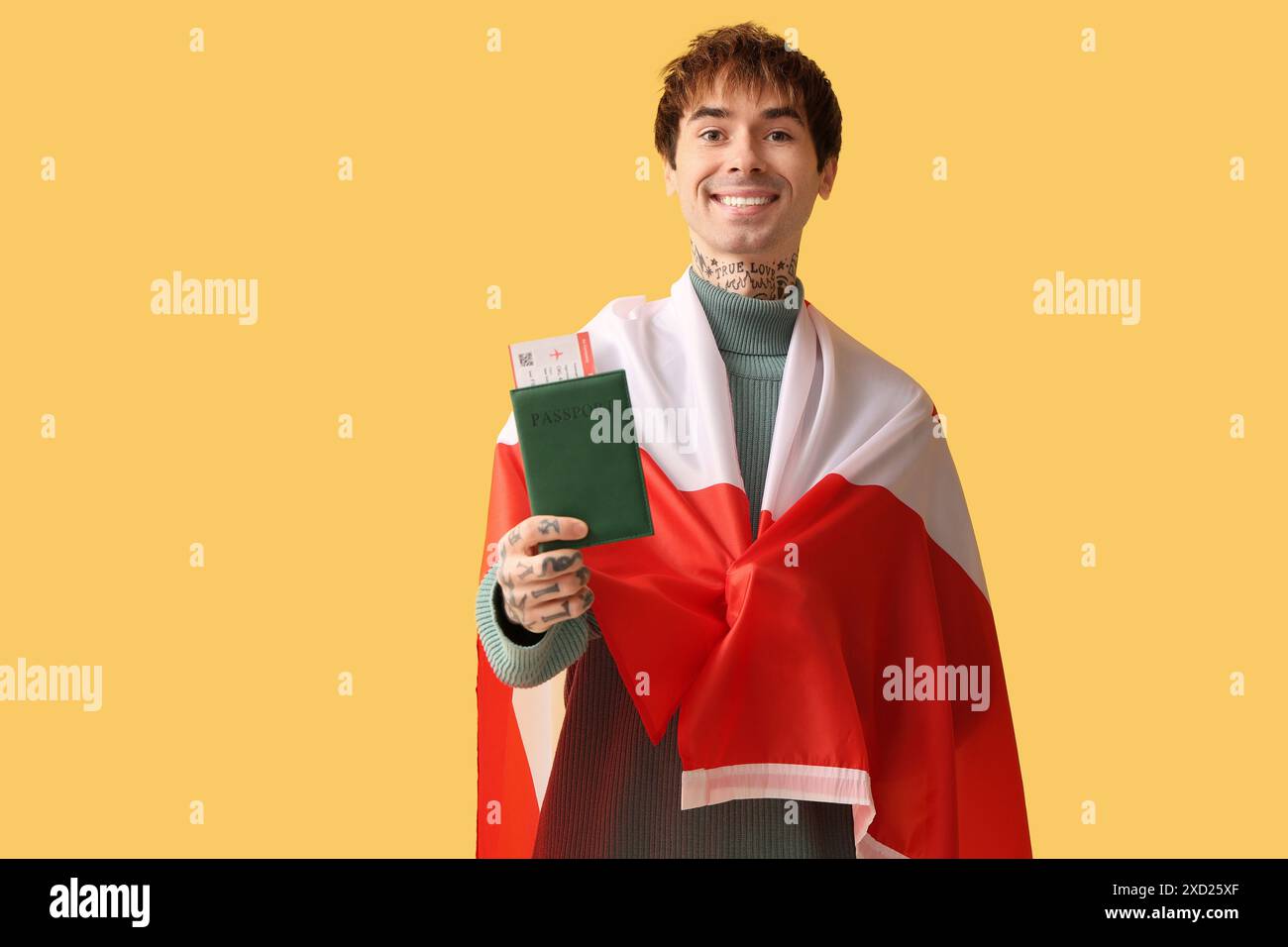 Handsome young man with flag of Canada and passport on yellow ...