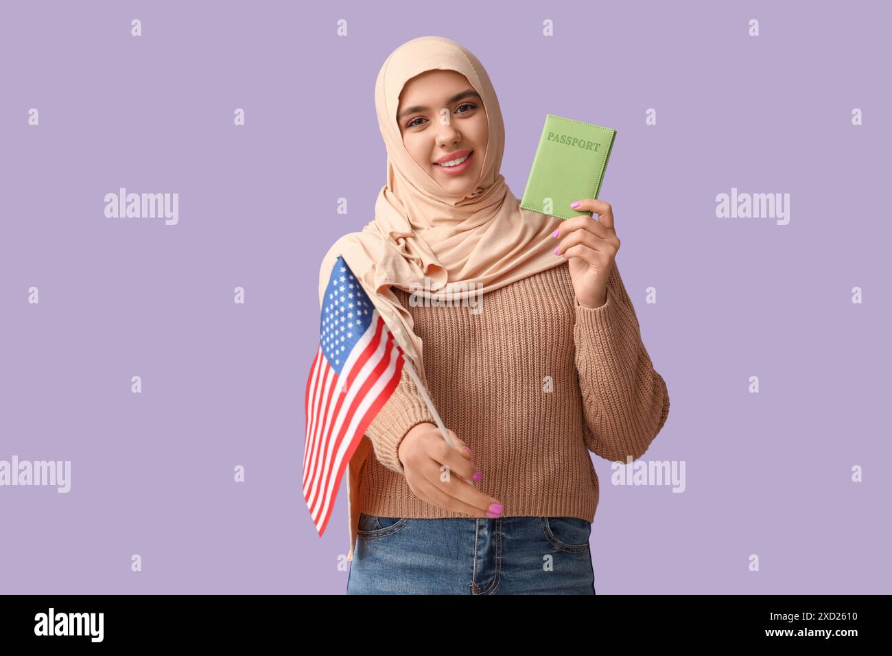 Beautiful young Muslim woman with USA flag and passport on purple ...