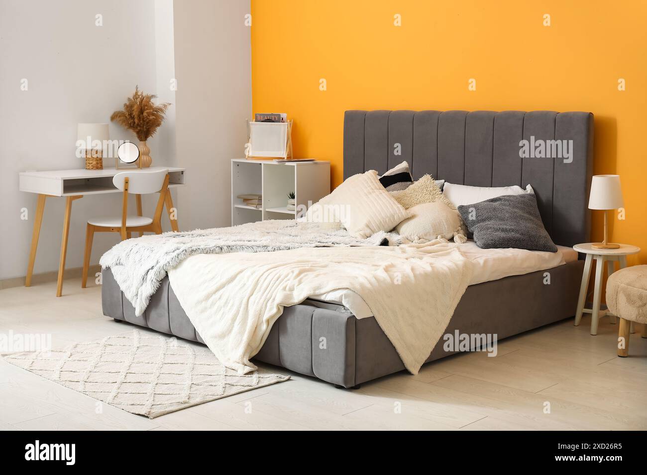 Modern bedroom with bed, bedside table and workplace Stock Photo - Alamy