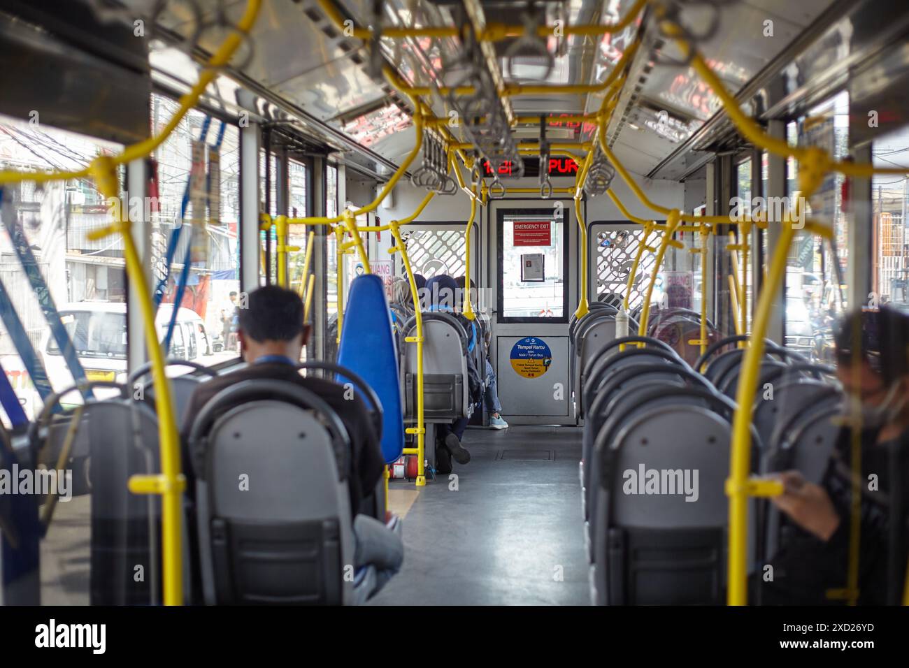 The interior of the Trans Jakarta bus seen from the rear passenger seat ...
