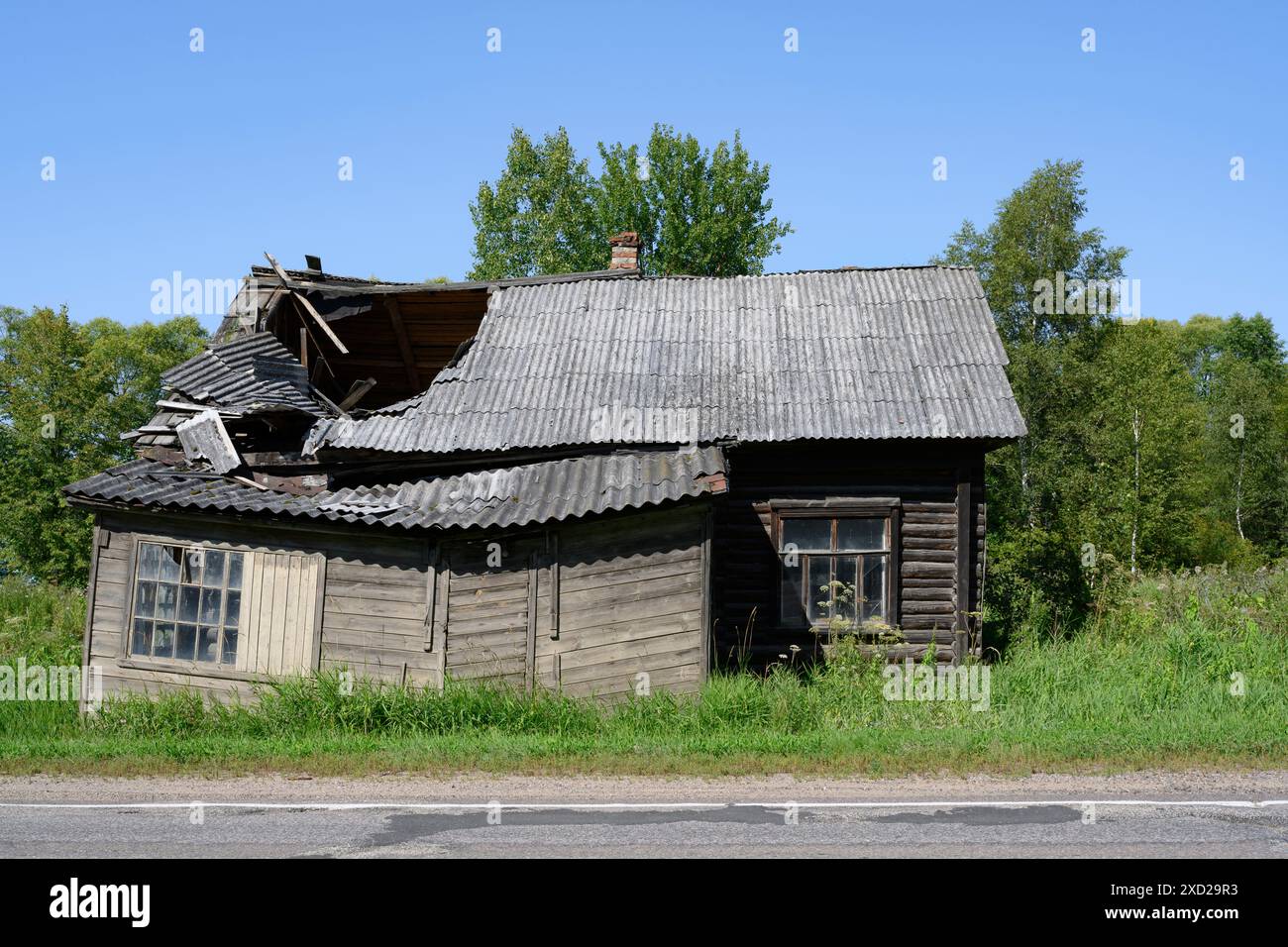 Abandoned dilapidated wooden village house by the road in Karelia Stock ...