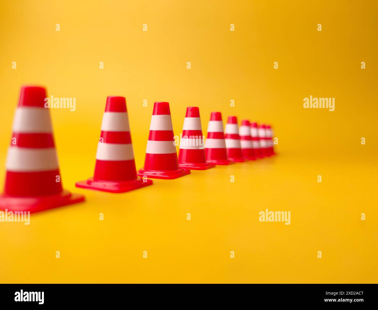 Mini plastic cones that have been arranged on a yellow background Stock ...