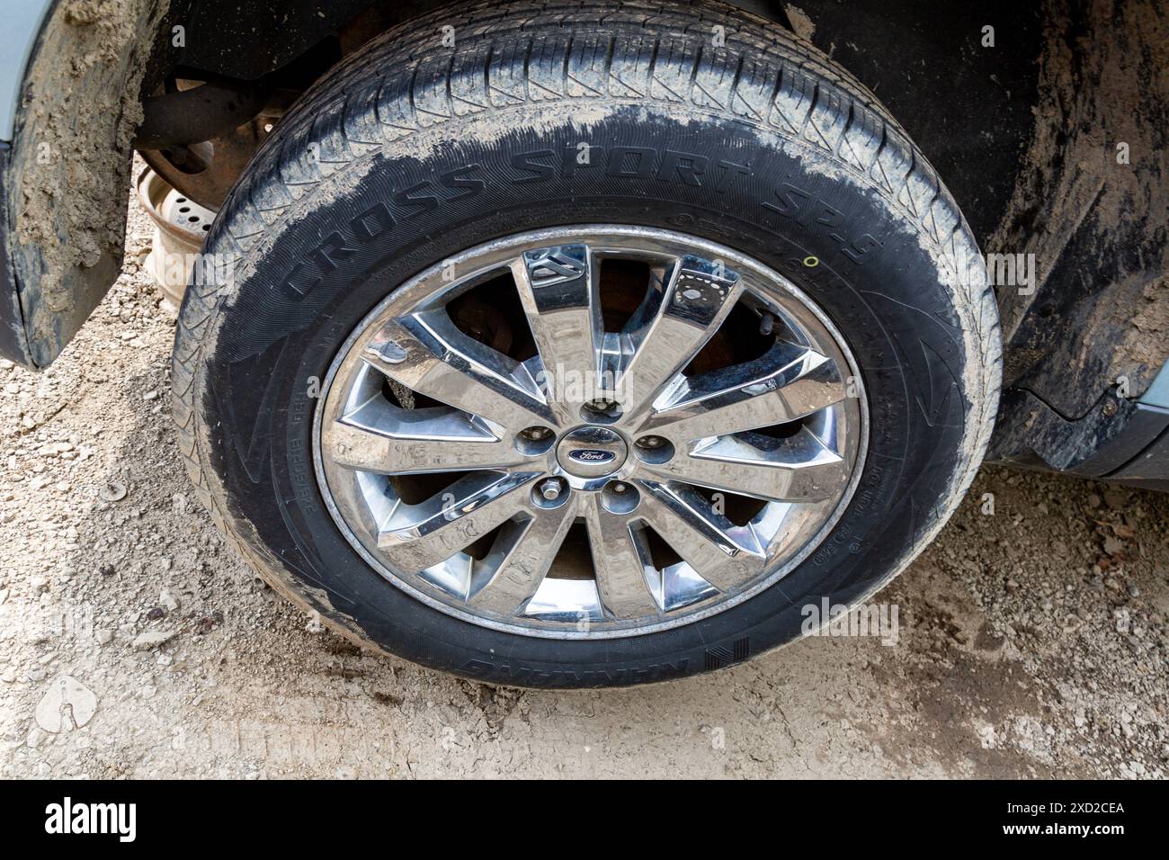 A chrome Ford wheel with a mounted Nankang Cross Sport SP-9 tire Stock ...