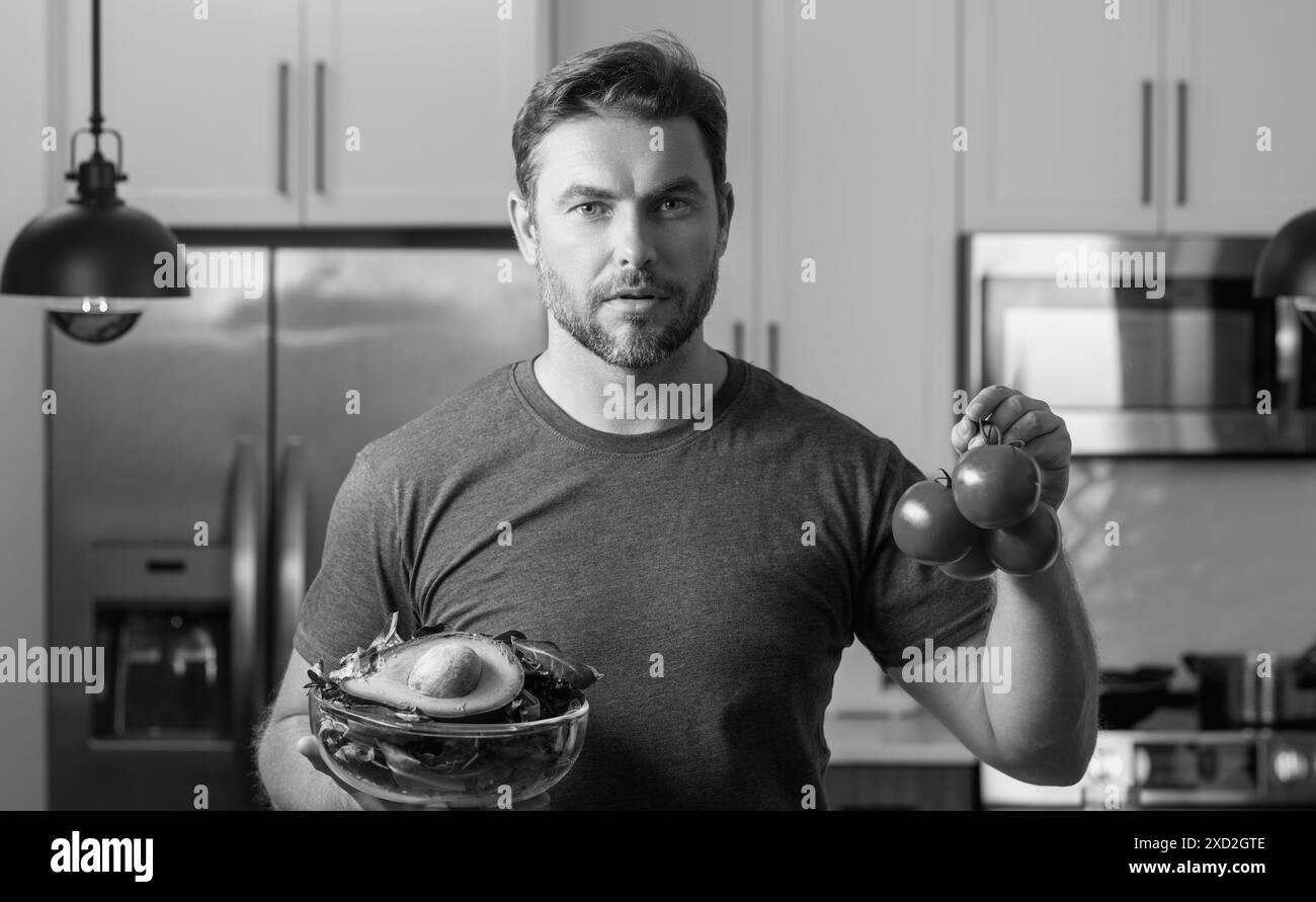 Middle aged man cooking in kitchen. Man on kitchen with vegetables ...