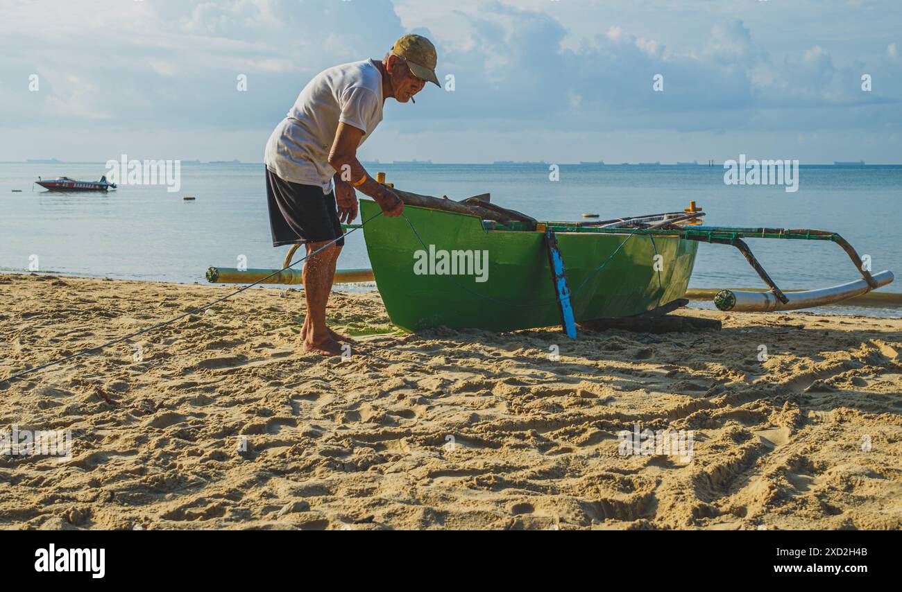 Balikpapan, Indonesia - April 16th, 2024. He is wearing a cap and ...