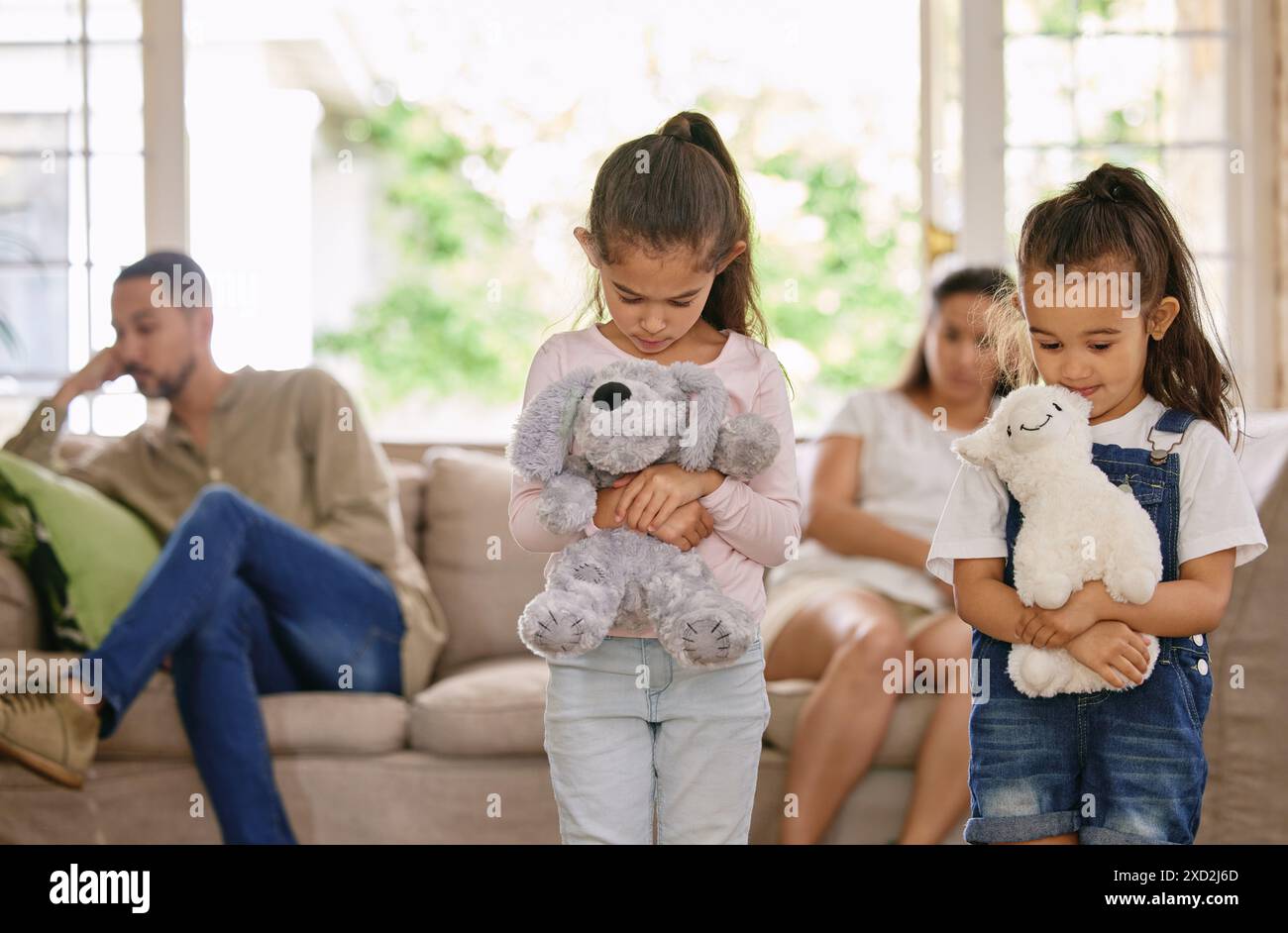 Parents, fighting and sad girls in living room with teddy bear for ...