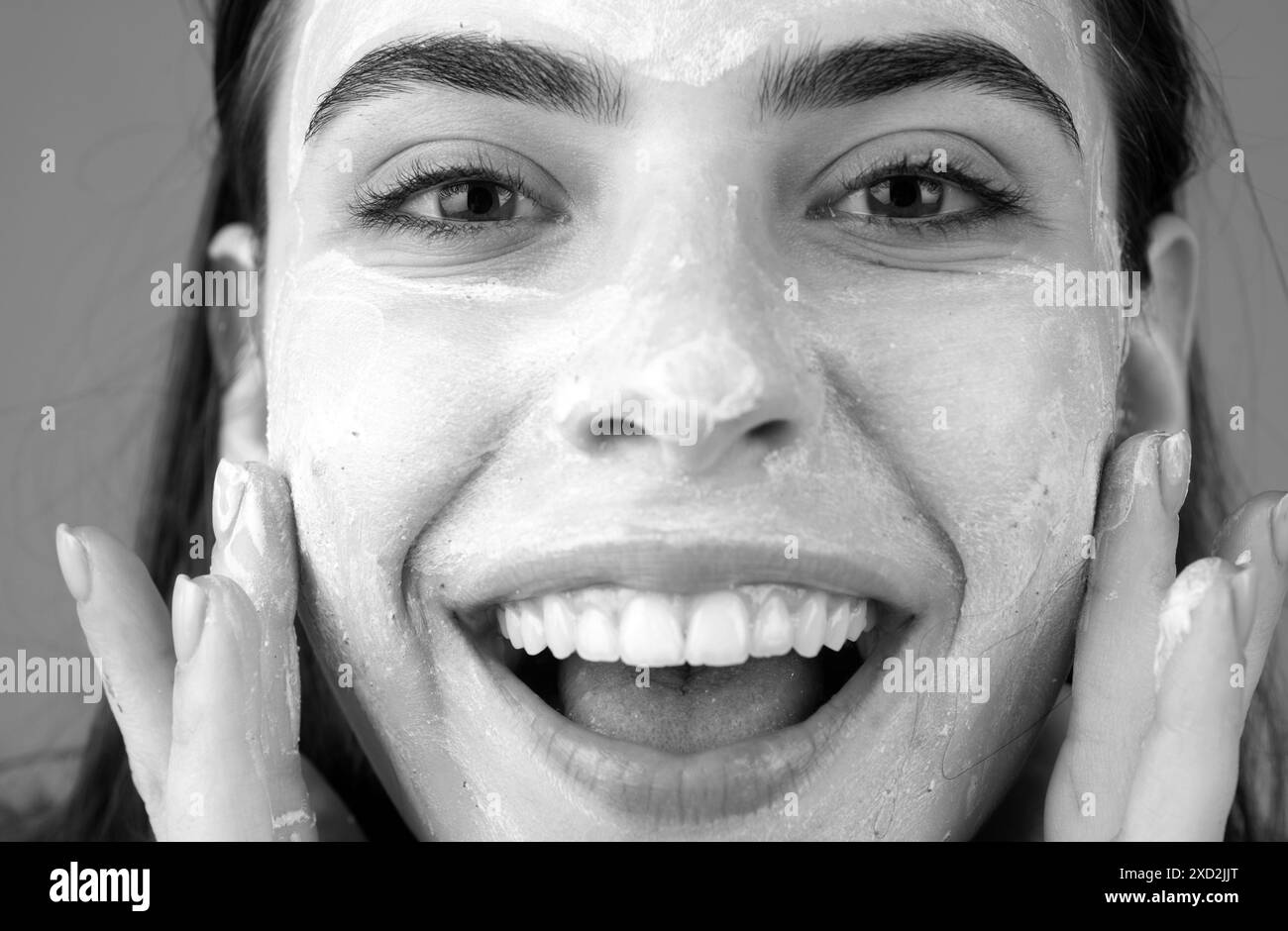 Close up woman facial mask, face clay. Beautiful smiling woman with ...