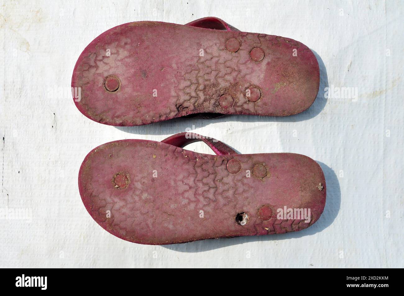 Worn and ugly flip flops on white background Stock Photo - Alamy