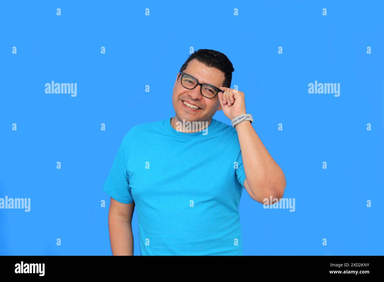 A 40-year-old dark-skinned Latino man uses eyeglasses to see better ...