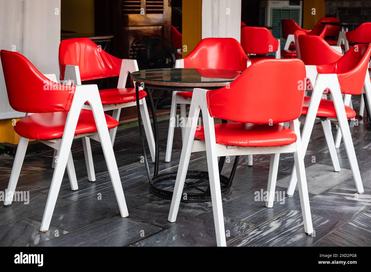 Street cafe with tables and red chairs outdoor. Empty dining table and ...
