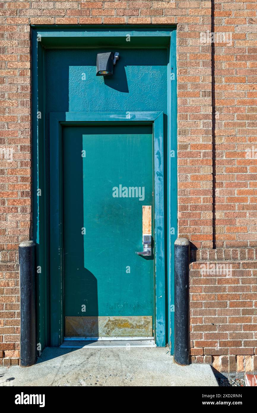 Green door with a keypad lock on an old red brick building Stock Photo ...