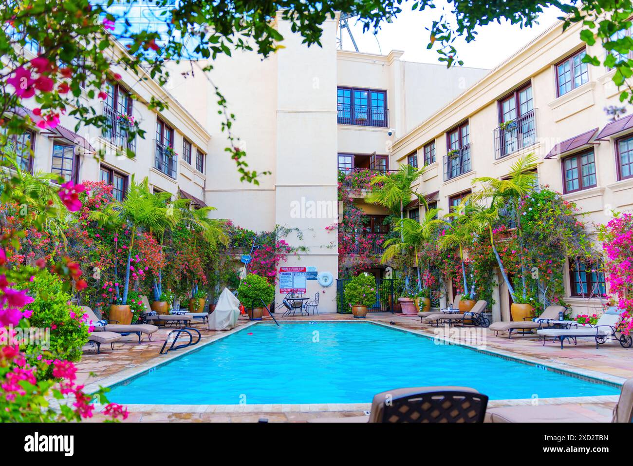 Los Angeles, California - April 1, 2024: Courtyard pool area with ...
