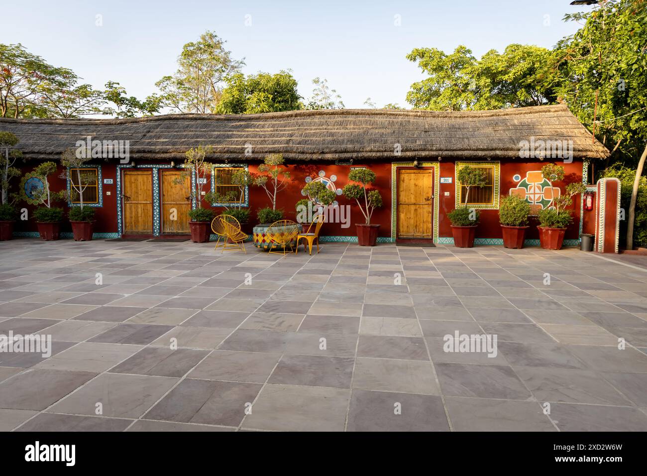 colorful artistic designed traditional teak and bush home at evening ...