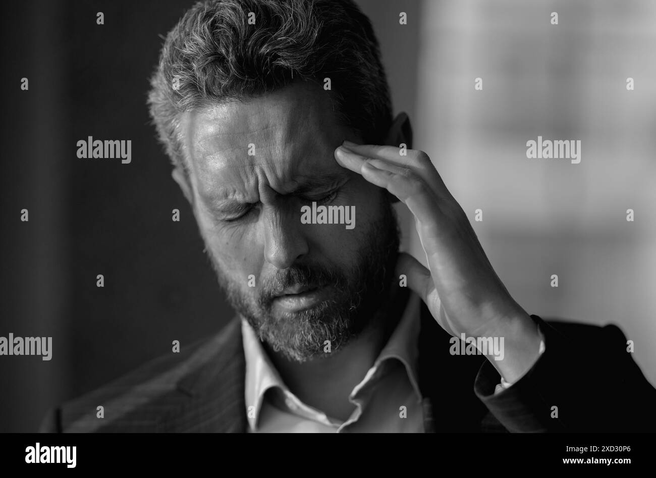 Man with sinus headache, tension or cluster headache, close up portrait ...