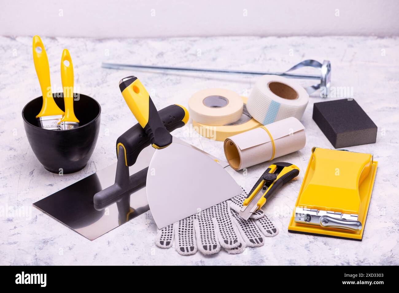 A set of hand tools for plastering and leveling the walls on white-grey ...