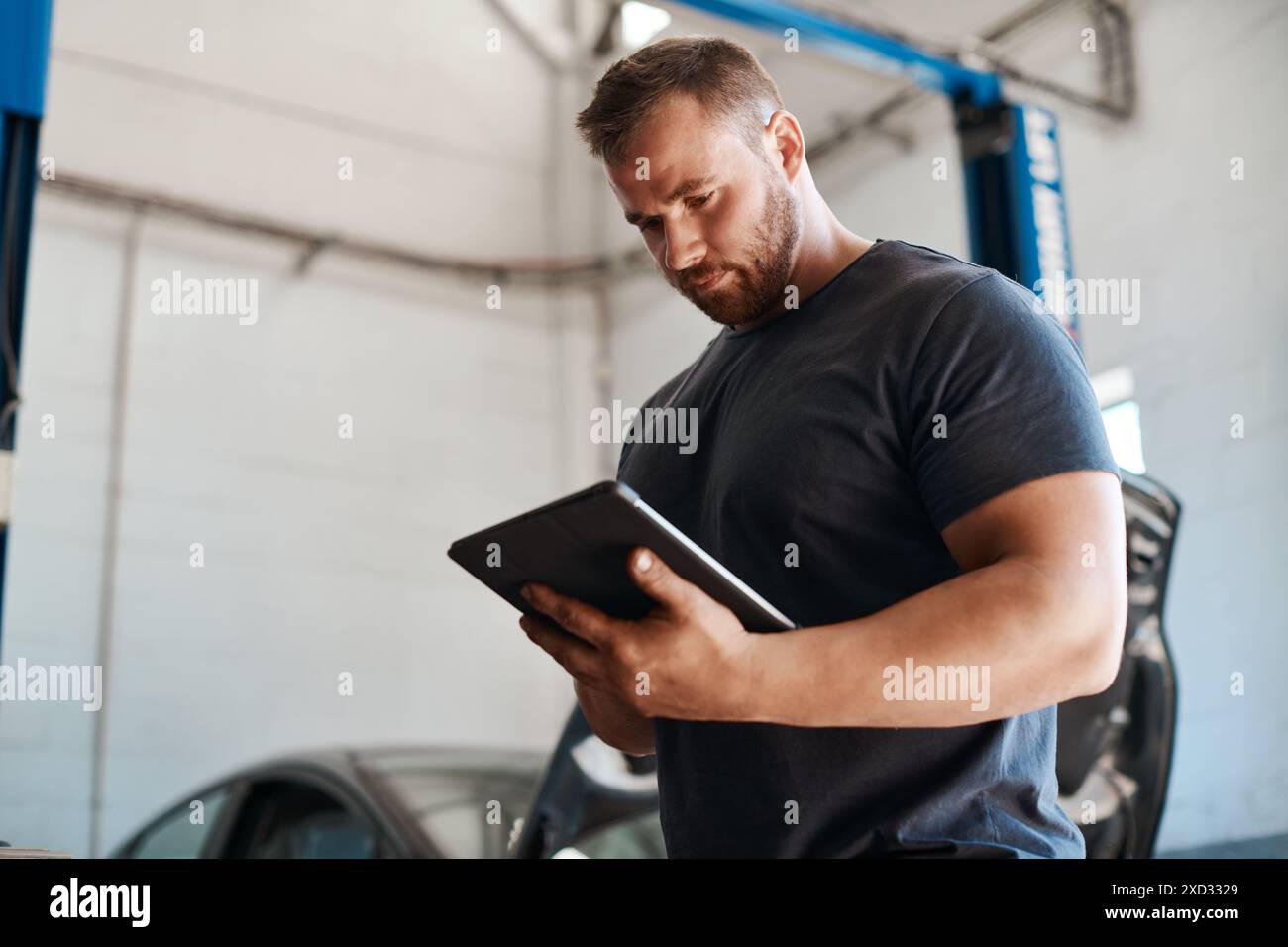 Man, car mechanic and workshop with tablet for maintenance or ...