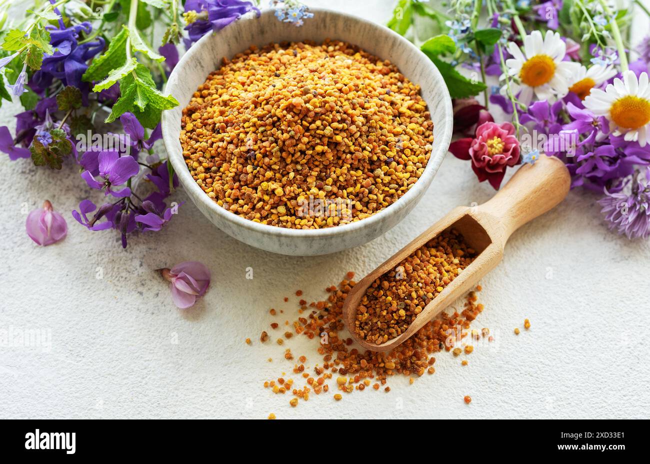 Healthy bee pollen grains. Bee pollen on a bowl and wild flowers Stock ...
