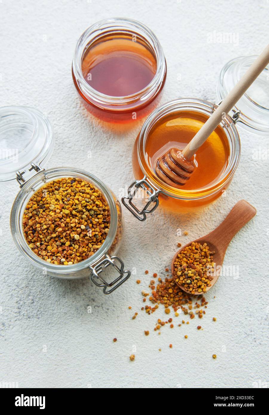 Raw organic bee pollen and honey in jars Stock Photo - Alamy