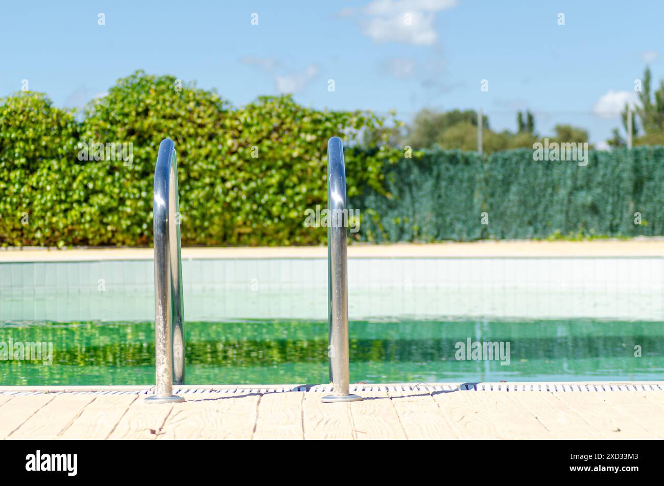 metal ladder of a swimming pool without maintenance Stock Photo - Alamy