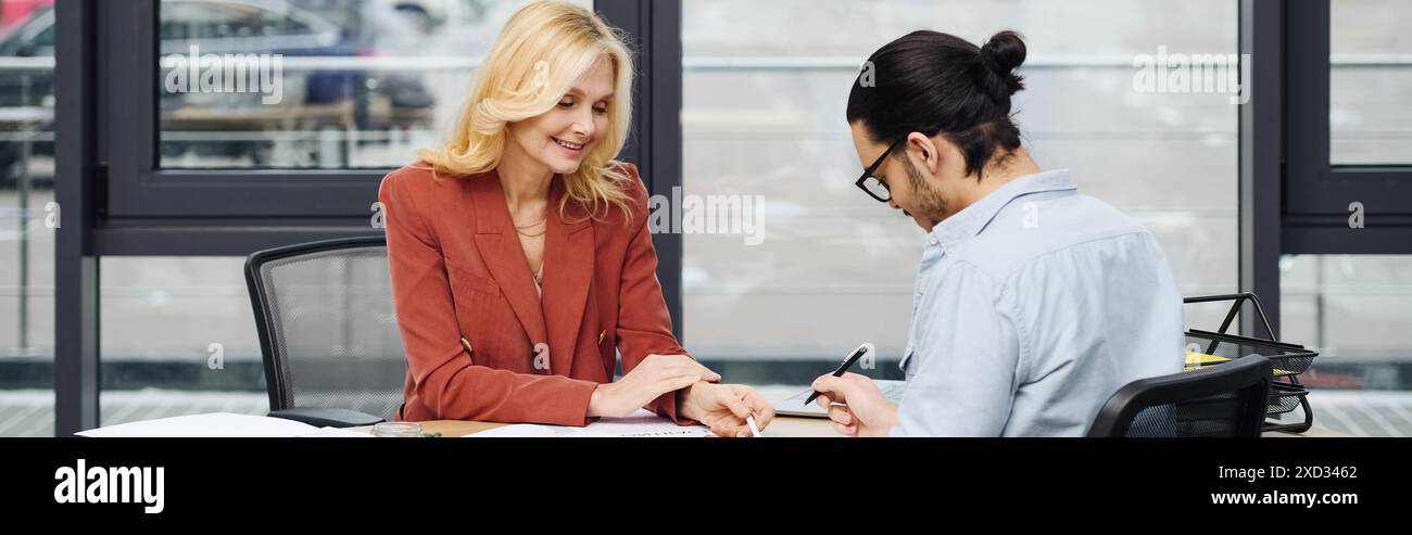 Two women engaged in a deep conversation at a desk Stock Photo - Alamy