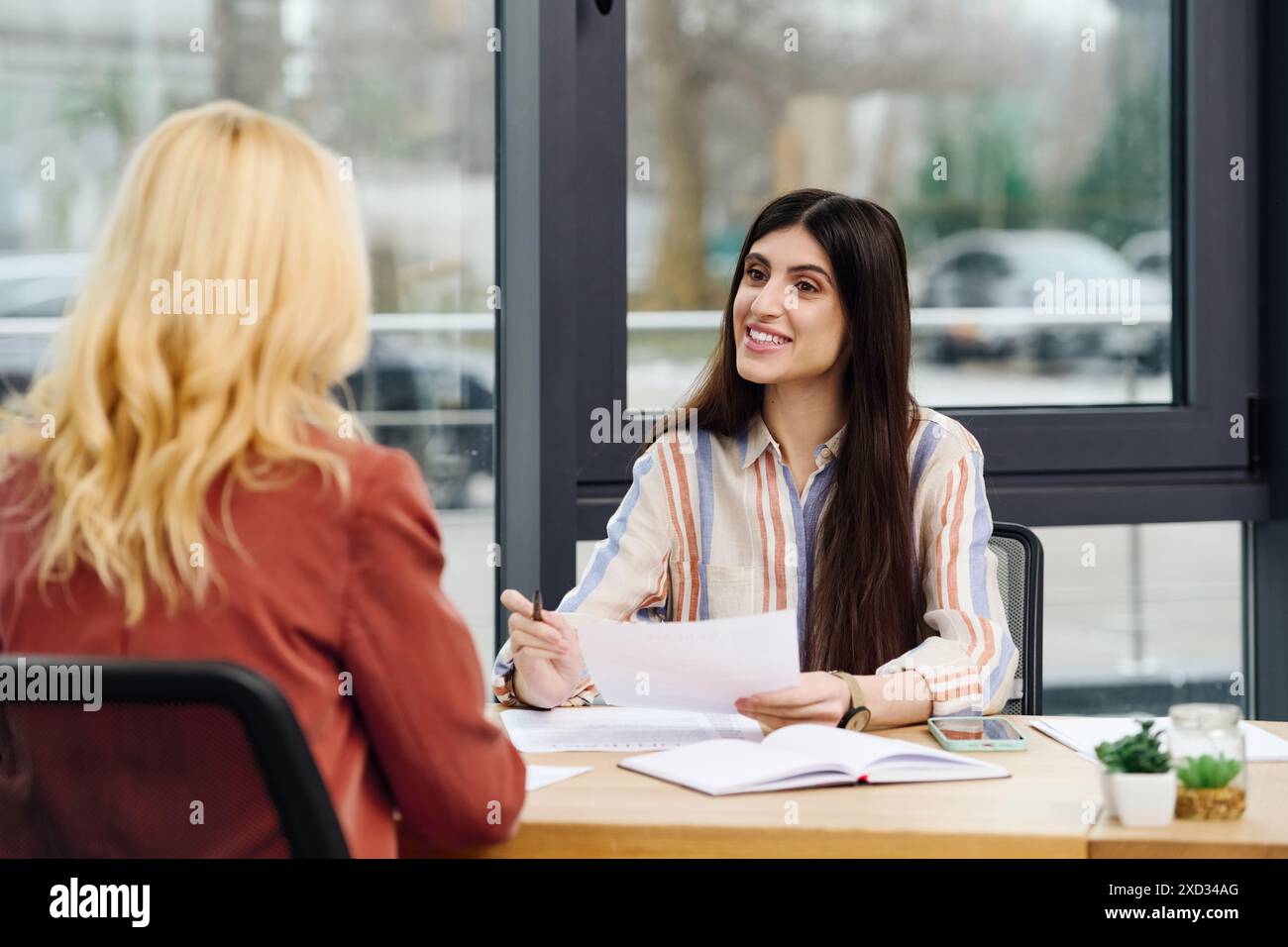 Two colleagues engage in collaborative hi-res stock photography and ...