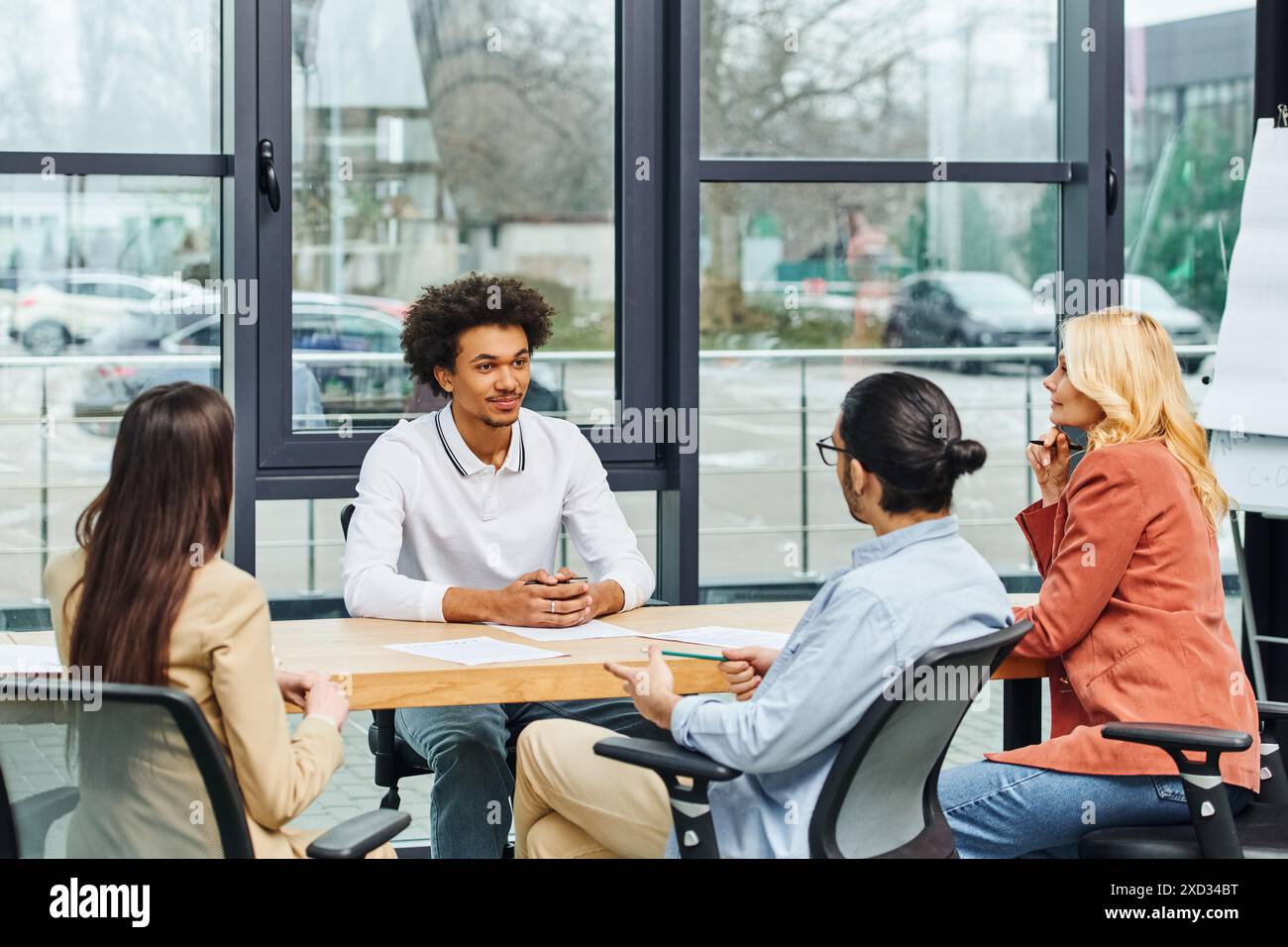 Group of professionals engaged in a meeting around a table in an office ...