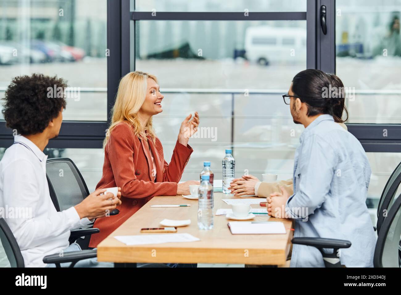Group of professionals discussing ideas around a table in a ...