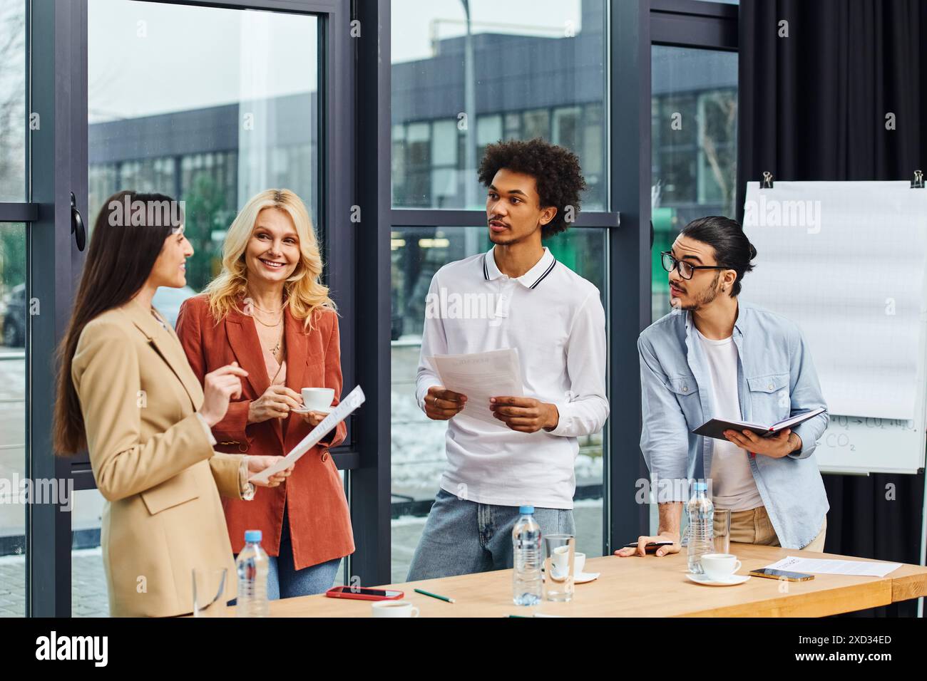 A diverse group of professionals engaged in a discussion at a meeting ...