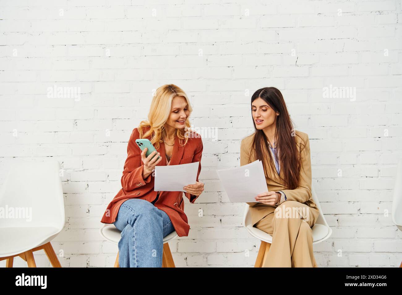 Two attractive women seated hi-res stock photography and images - Alamy
