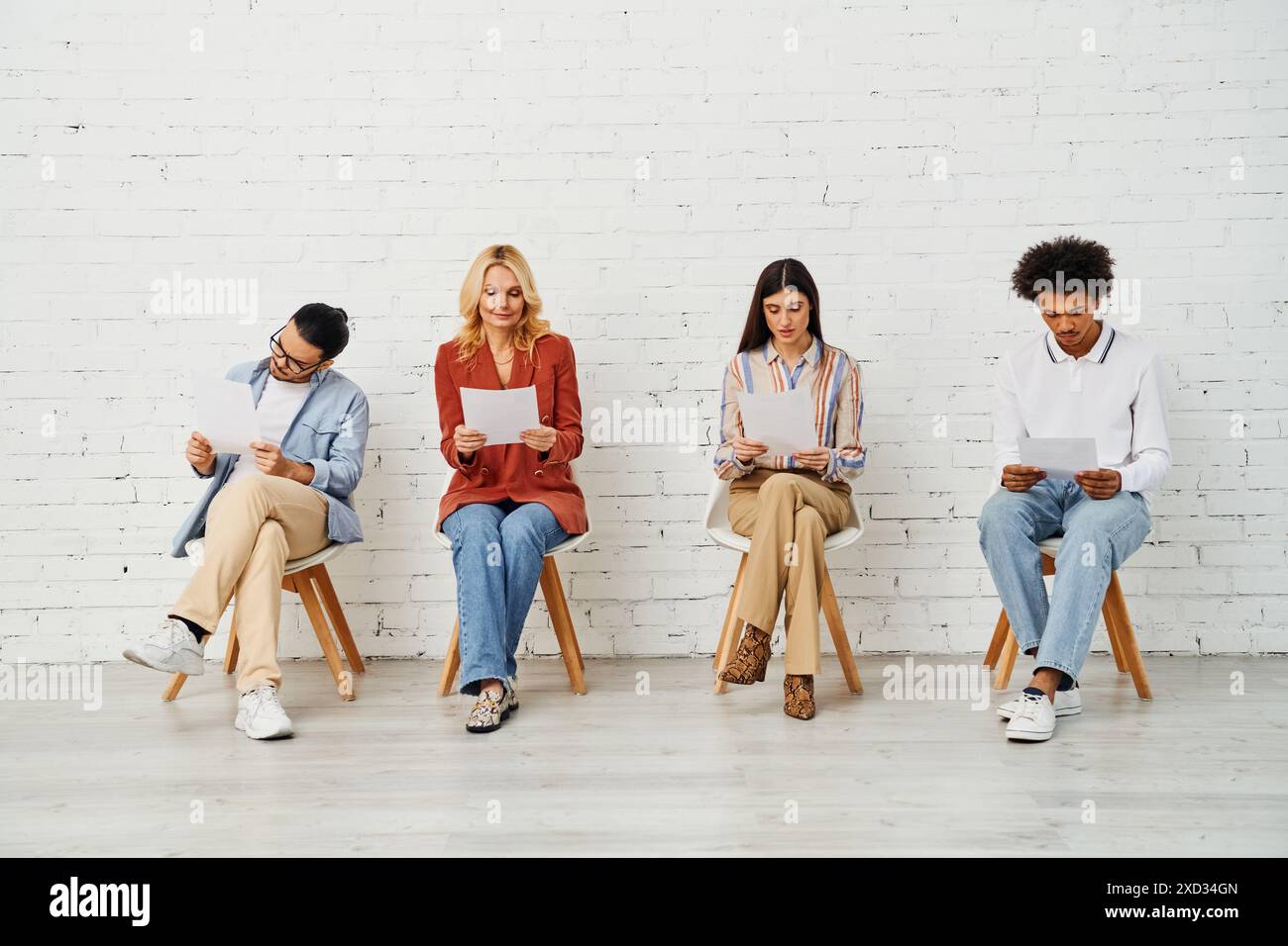 Diverse group seated, absorbed in reading papers Stock Photo - Alamy