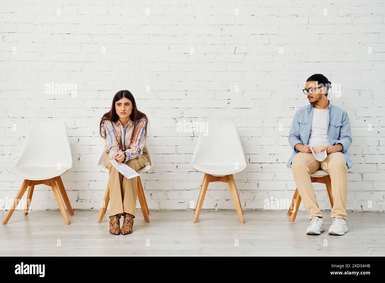 Diverse group sitting in chairs, preparing for job interviews Stock ...