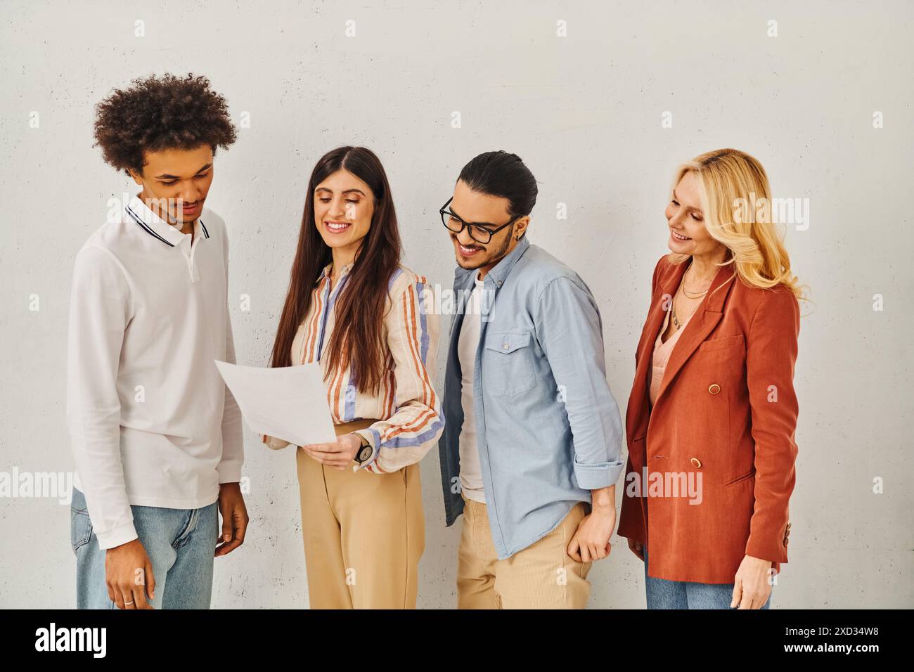 Diverse group of people engrossed in reading a document together Stock ...