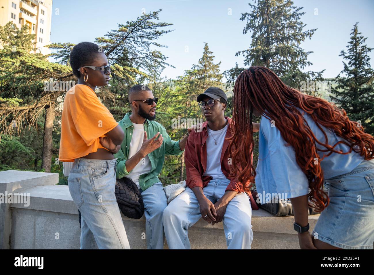 Sympathetic participating black friends students sitting together at ...