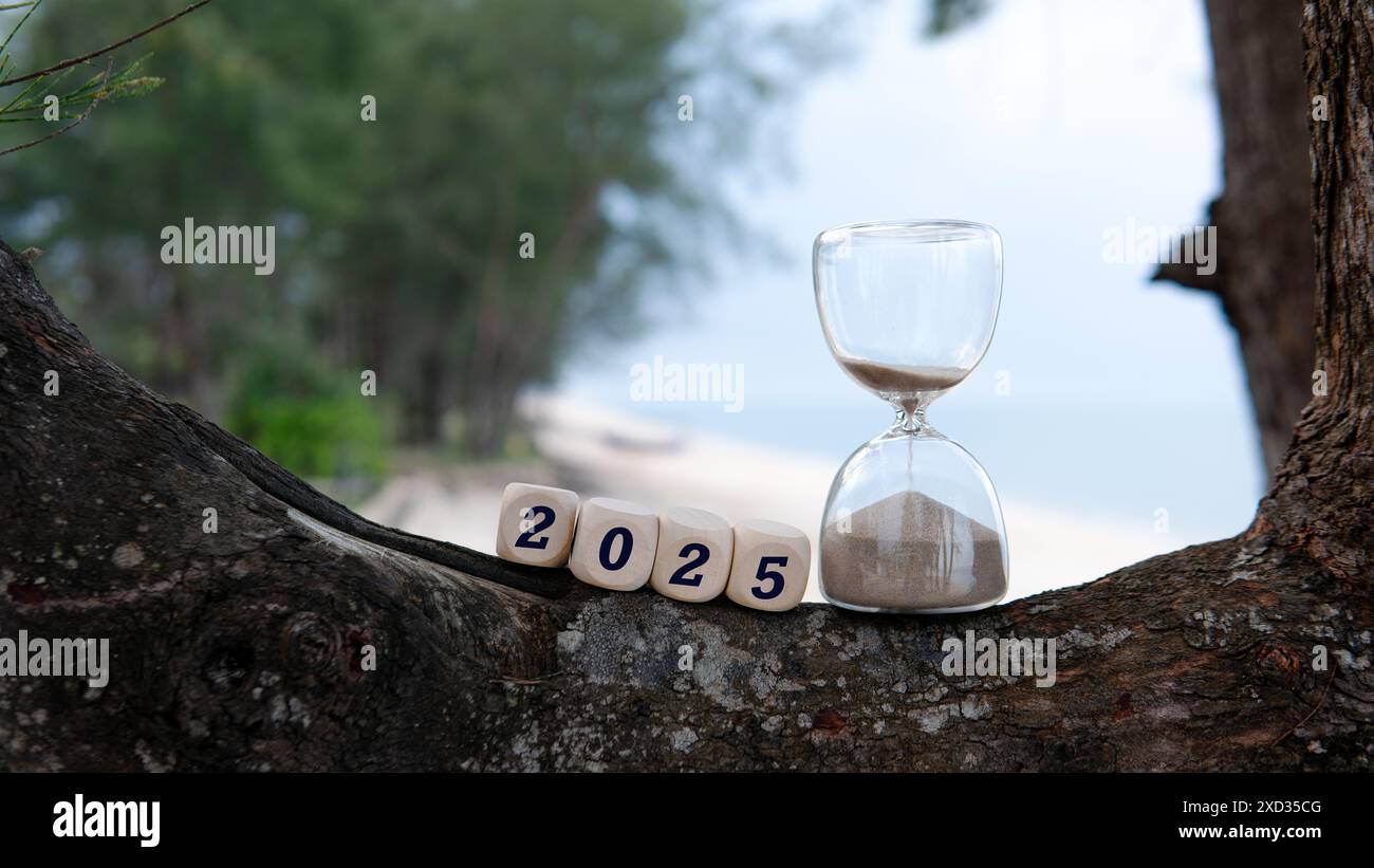 An hour glass with a dice cube and a text 2025 as a symbolic that the ...