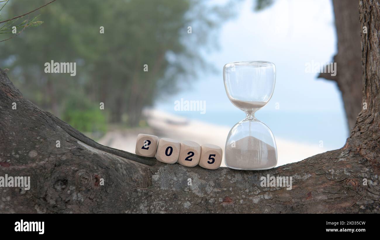 An hour glass with a dice cube and a text 2025 as a symbolic that the ...