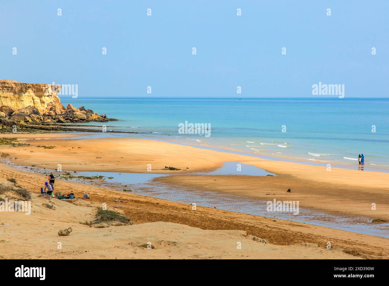 Sunny day's leisure time at a picturesque sandy beach in Persian Gulf ...