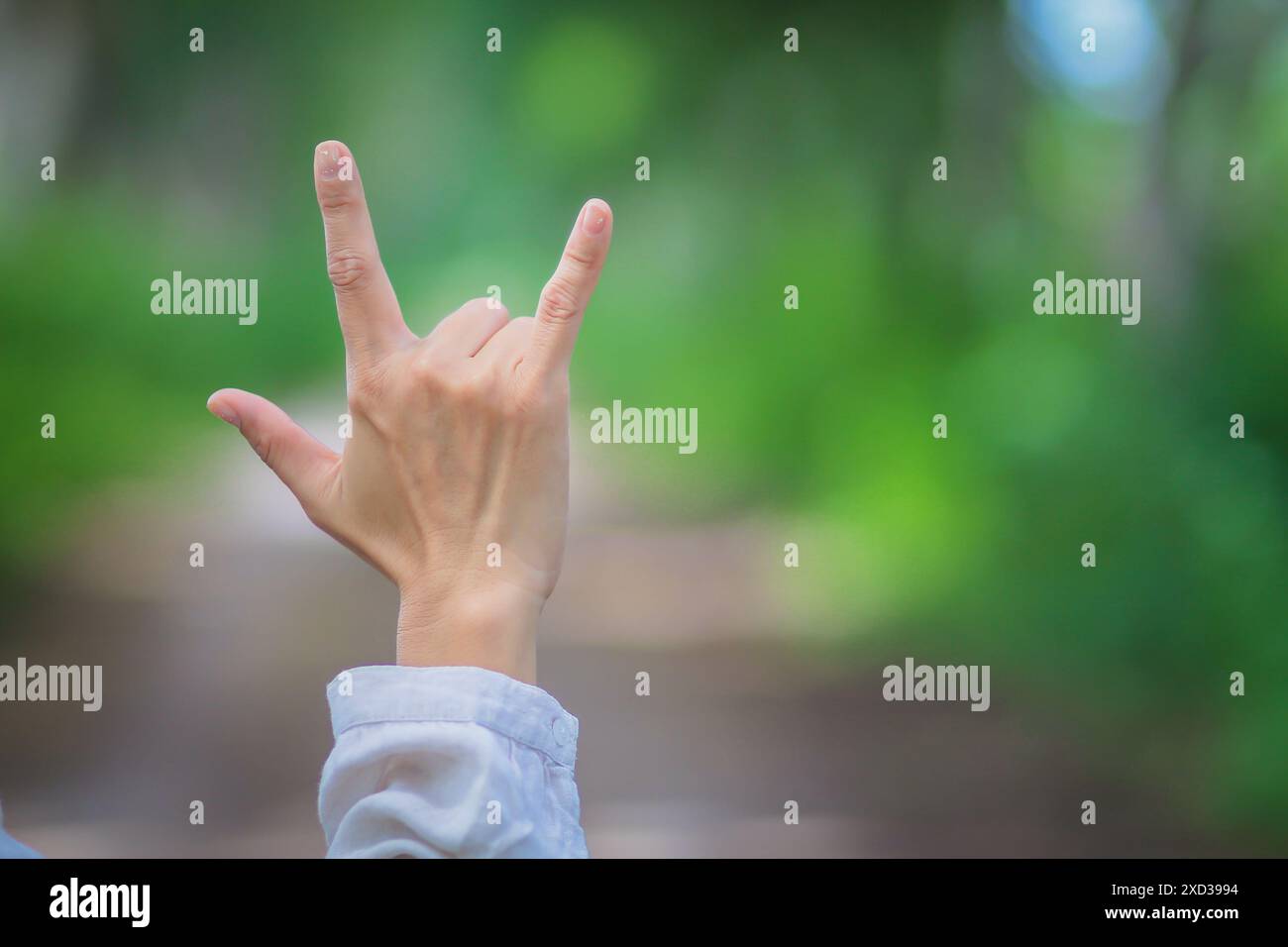man uses sign language I love you to express his love and friendship ...
