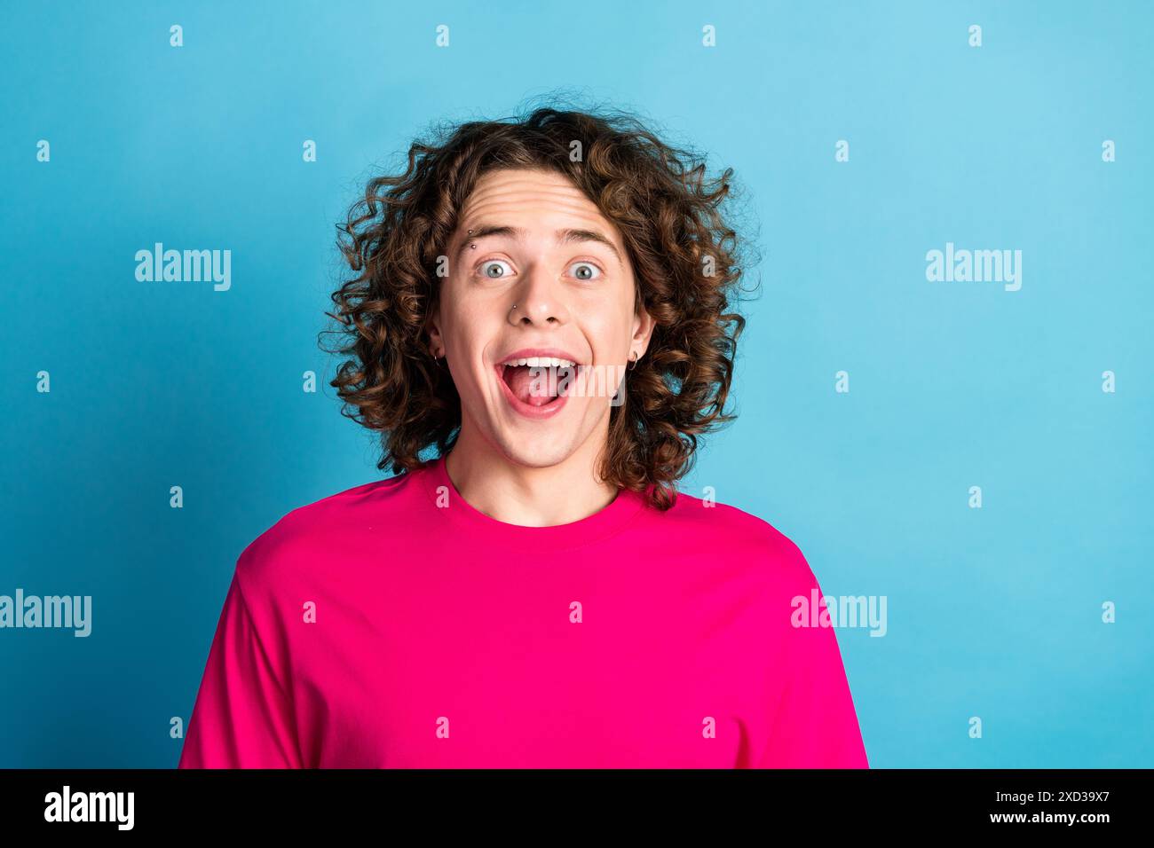 Photo of impressed ecstatic guy with wavy hairstyle earrings dressed ...