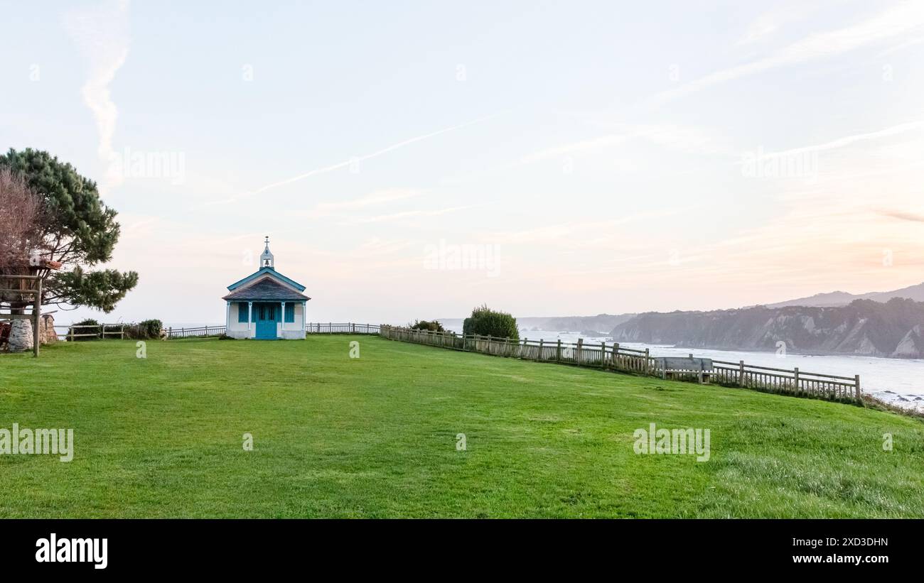 A serene coastal landscape featuring a small chapel against the ...