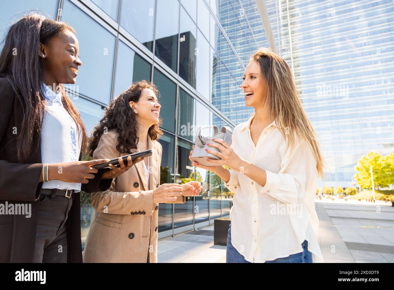Three black professional women of different ethnic backgrounds engage ...