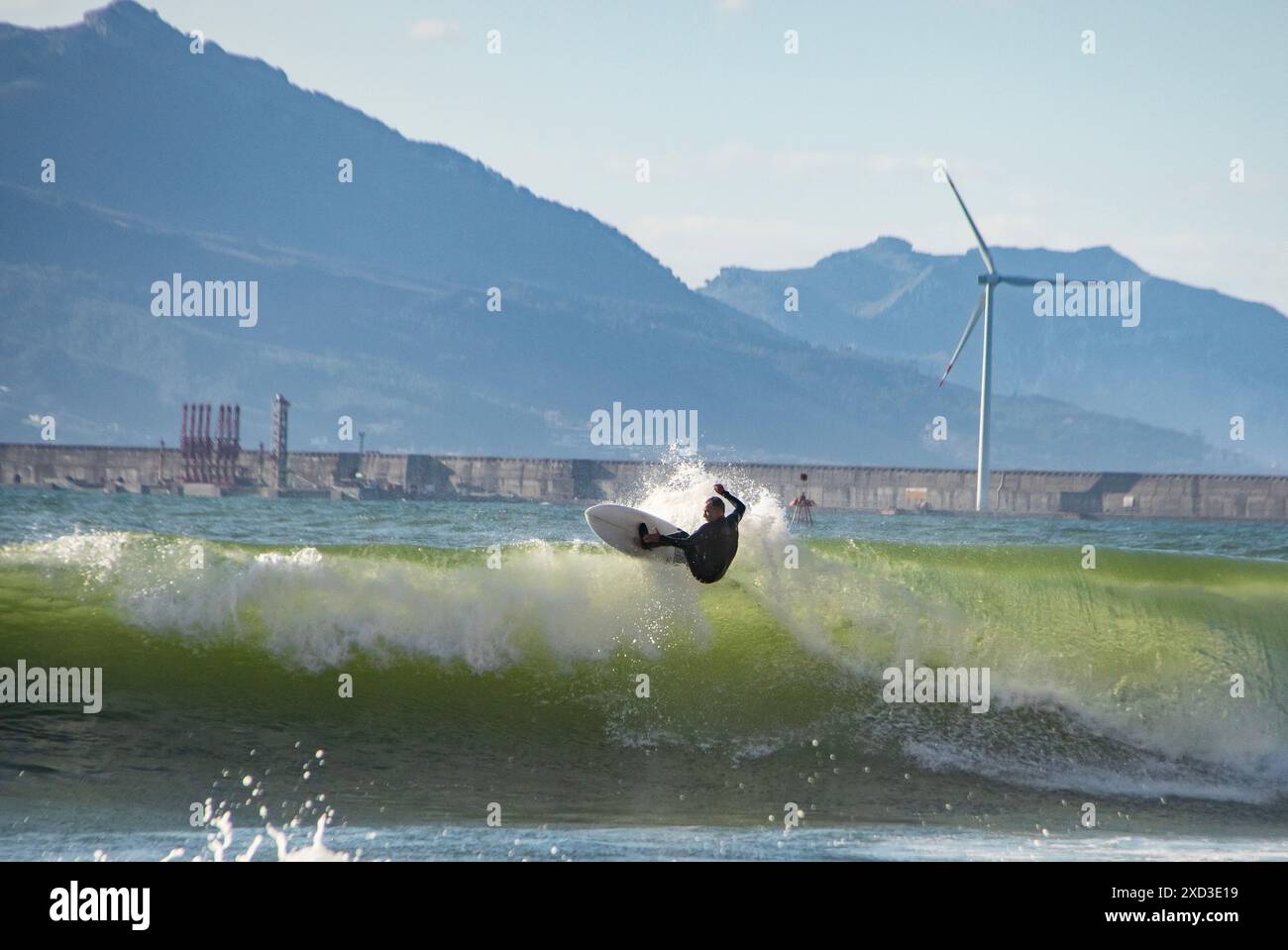 A dynamic surfing scene capturing a surfer riding a wave with a ...
