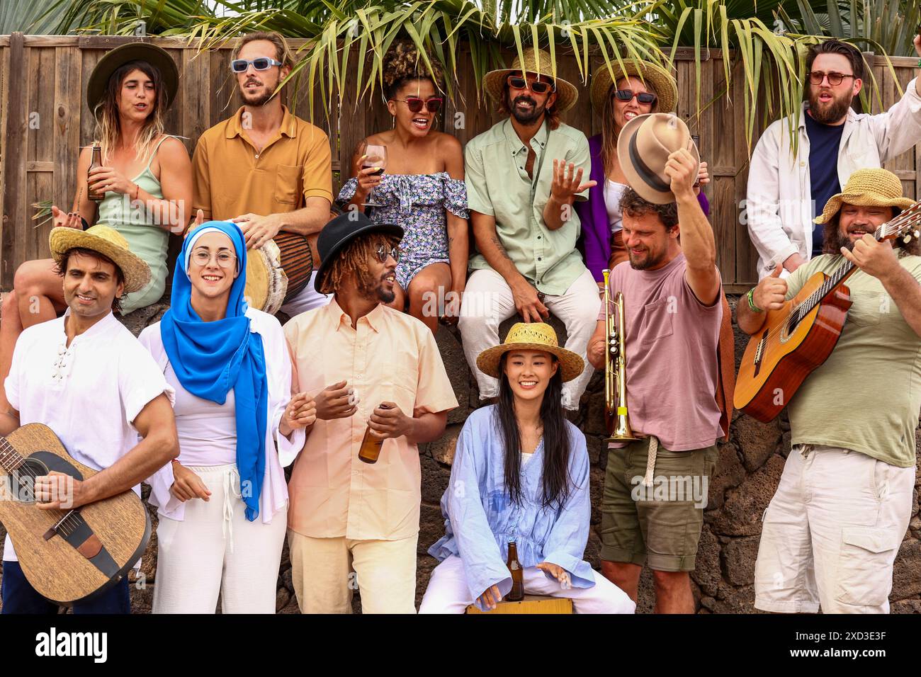 A multiracial group of friends gathers for a party outdoors, sharing ...
