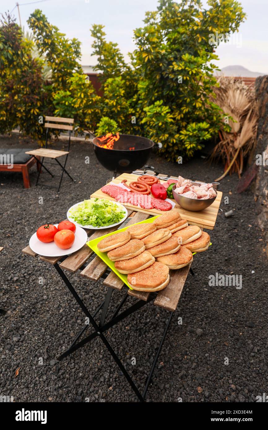 A vibrant setup for an outdoor barbecue featuring a variety of foods ...
