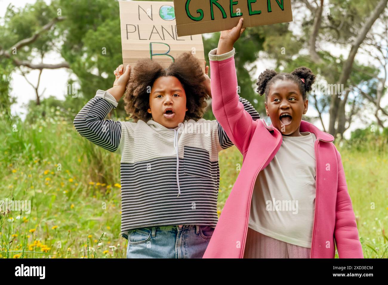 Two enthusiastic young girls holding signs about environmental ...
