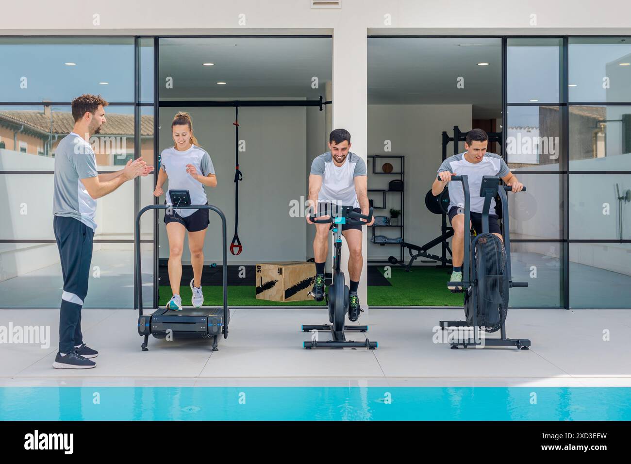 Four fitness enthusiasts engage in various exercises at a stylish ...