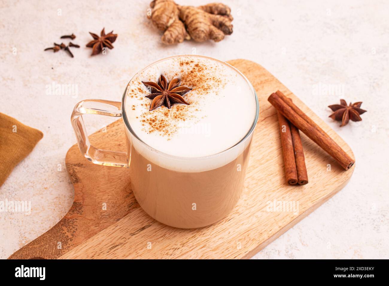 From above, chai latte with frothy milk, star anise, and cinnamon ...