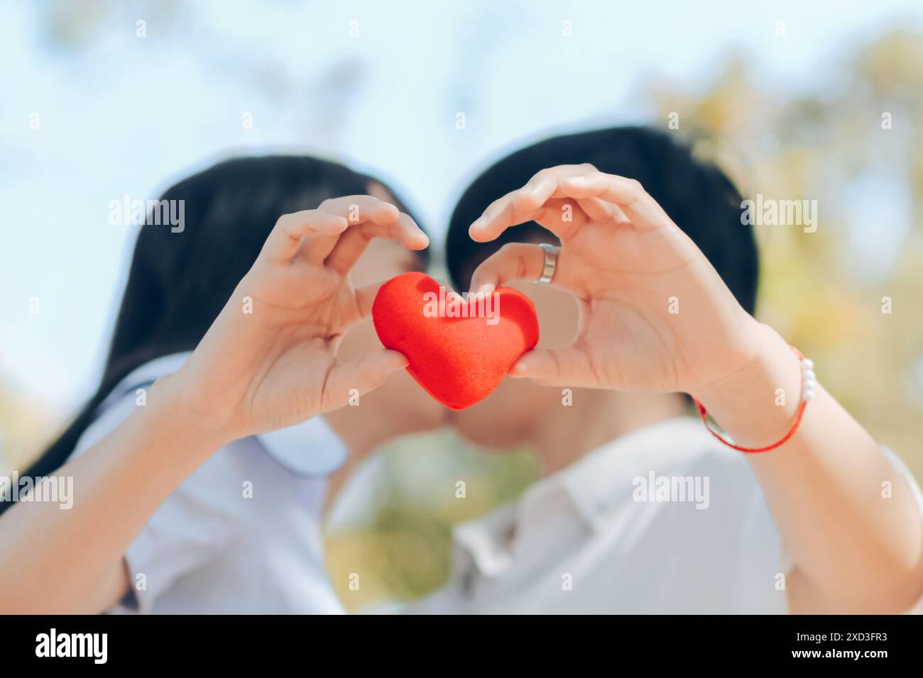 Couples display heart shaped symbols together to show their love and ...