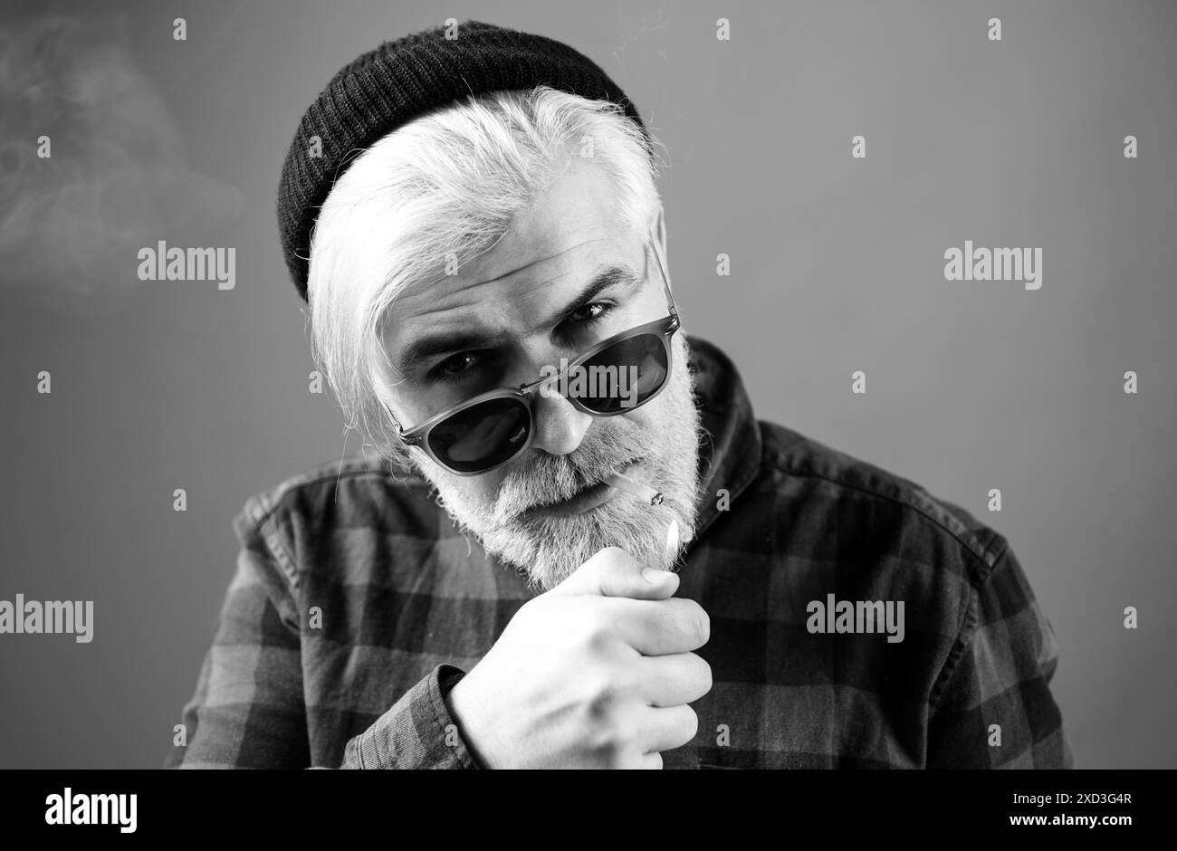 Man smoking. Close up face of a young man without emotions. Portrait ...