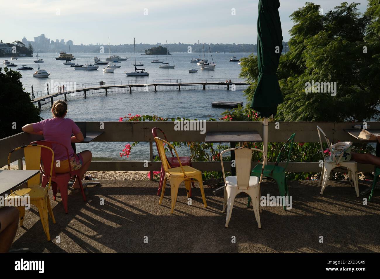 A woman looking out at Redleaf Beach and the Murray Rose Pool, a ...